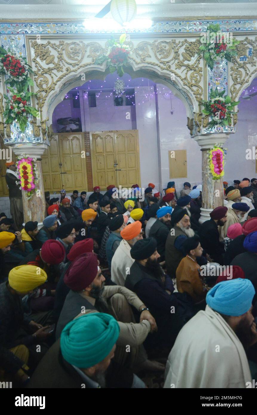 Peshawar, Pakistan. 28th Dec, 2022. Sikh devotees take part in a ...