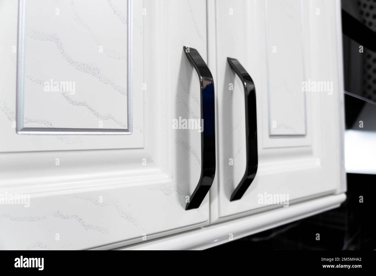 Modern kitchen interior. Handles on kitchen cabinets. Salon with ...