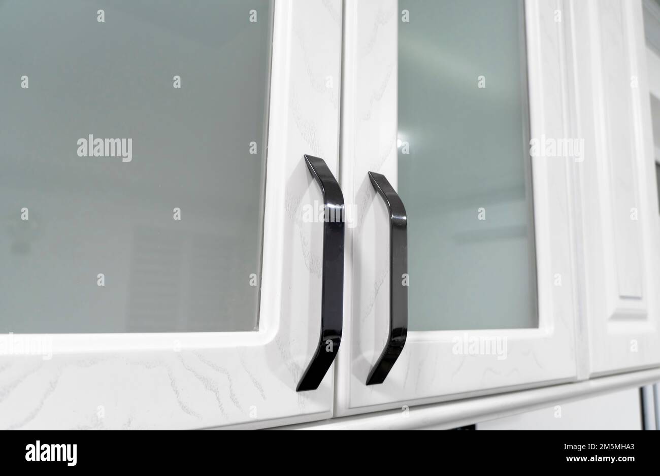 Modern kitchen interior. Handles on kitchen cabinets. Salon with ...