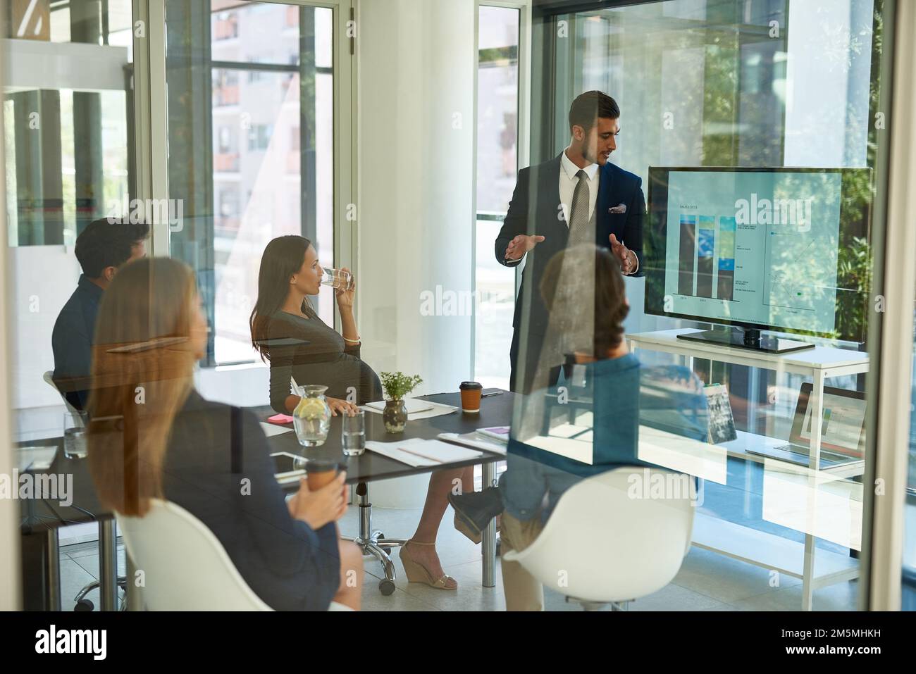 Taking stock and setting new targets. a corporate businessperson giving ...