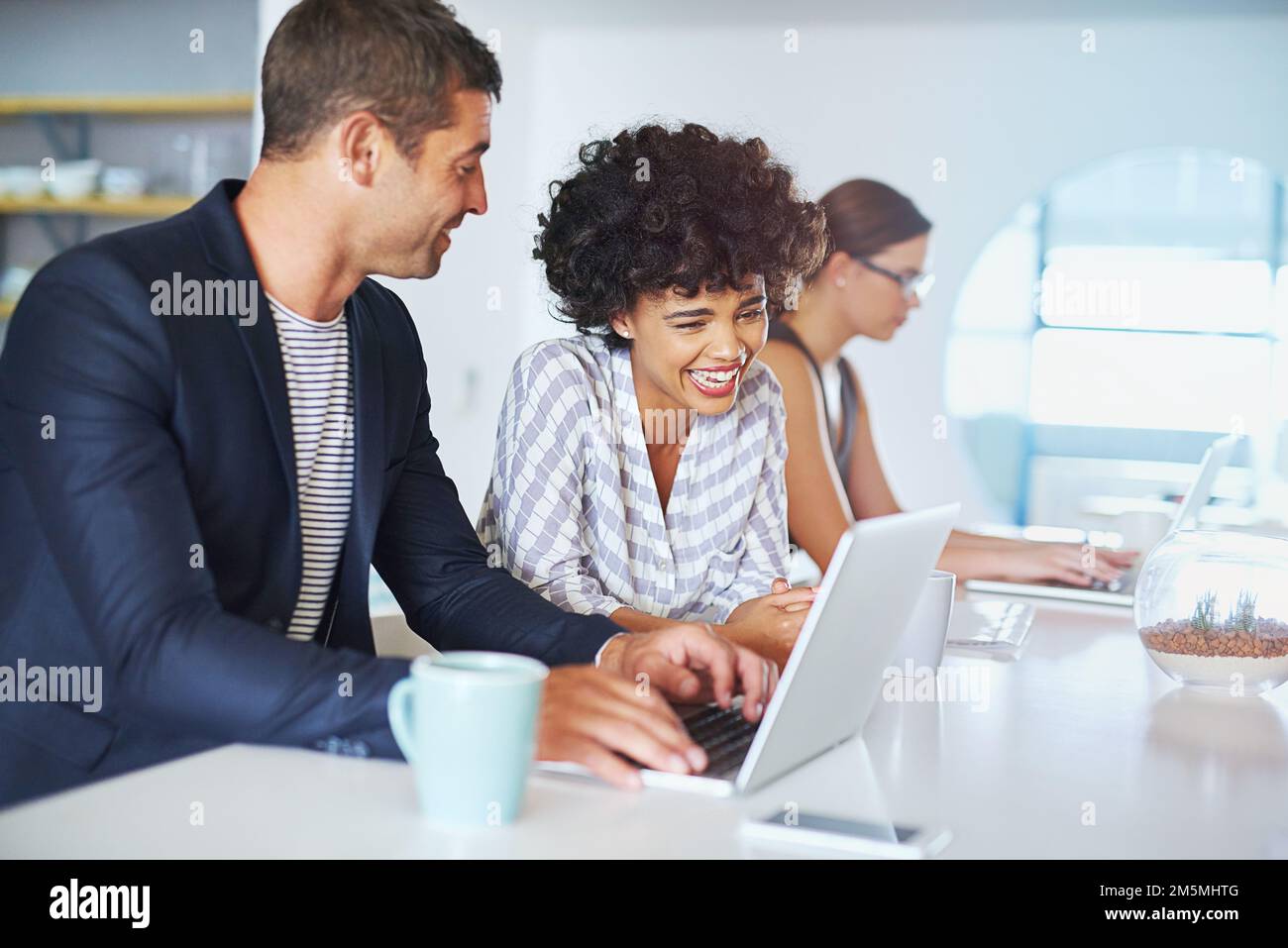 Success comes from hard work and amazing teamwork. coworkers using a ...