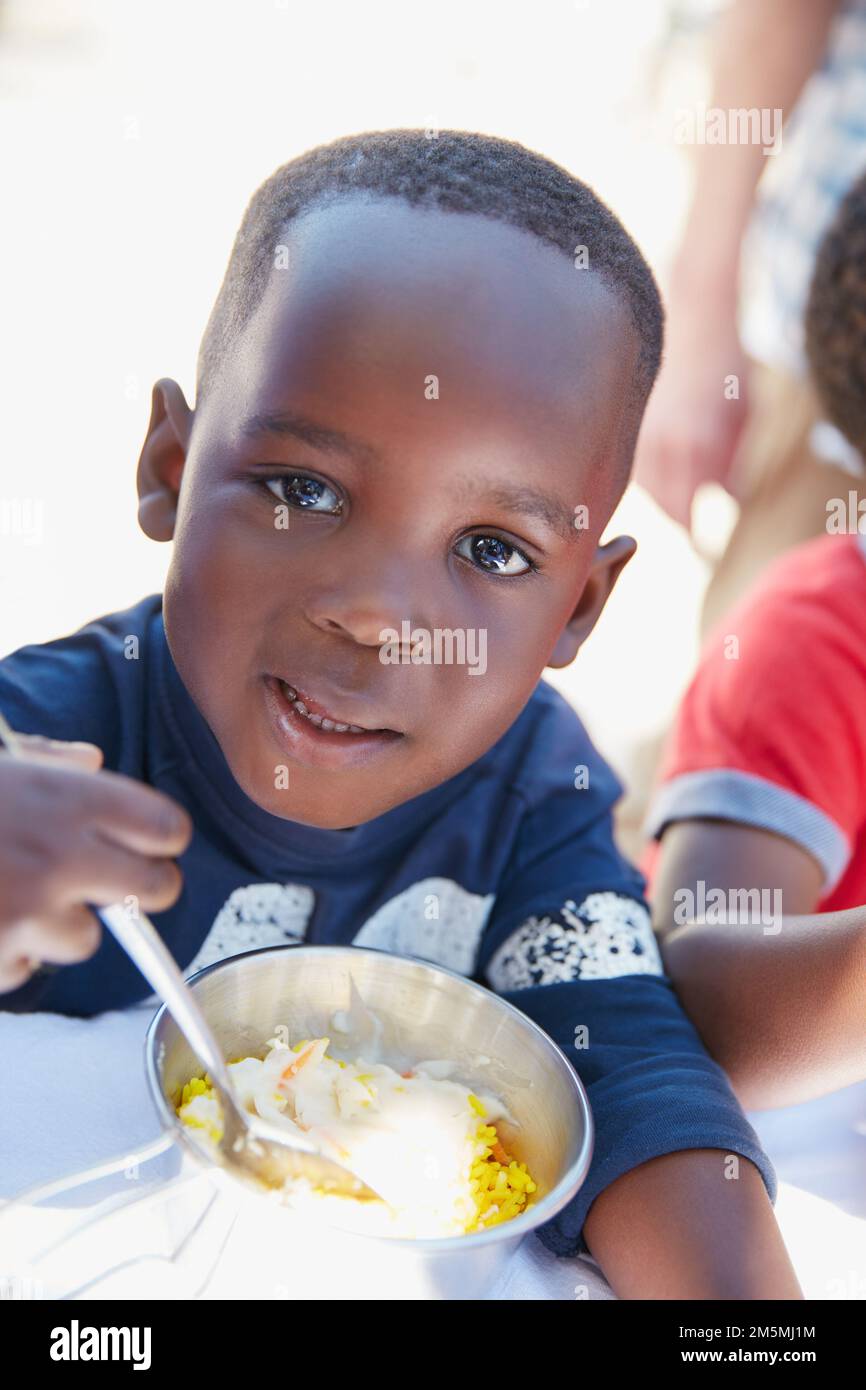 Its so good. Cropped portrait of a young boy getting fed at a food ...