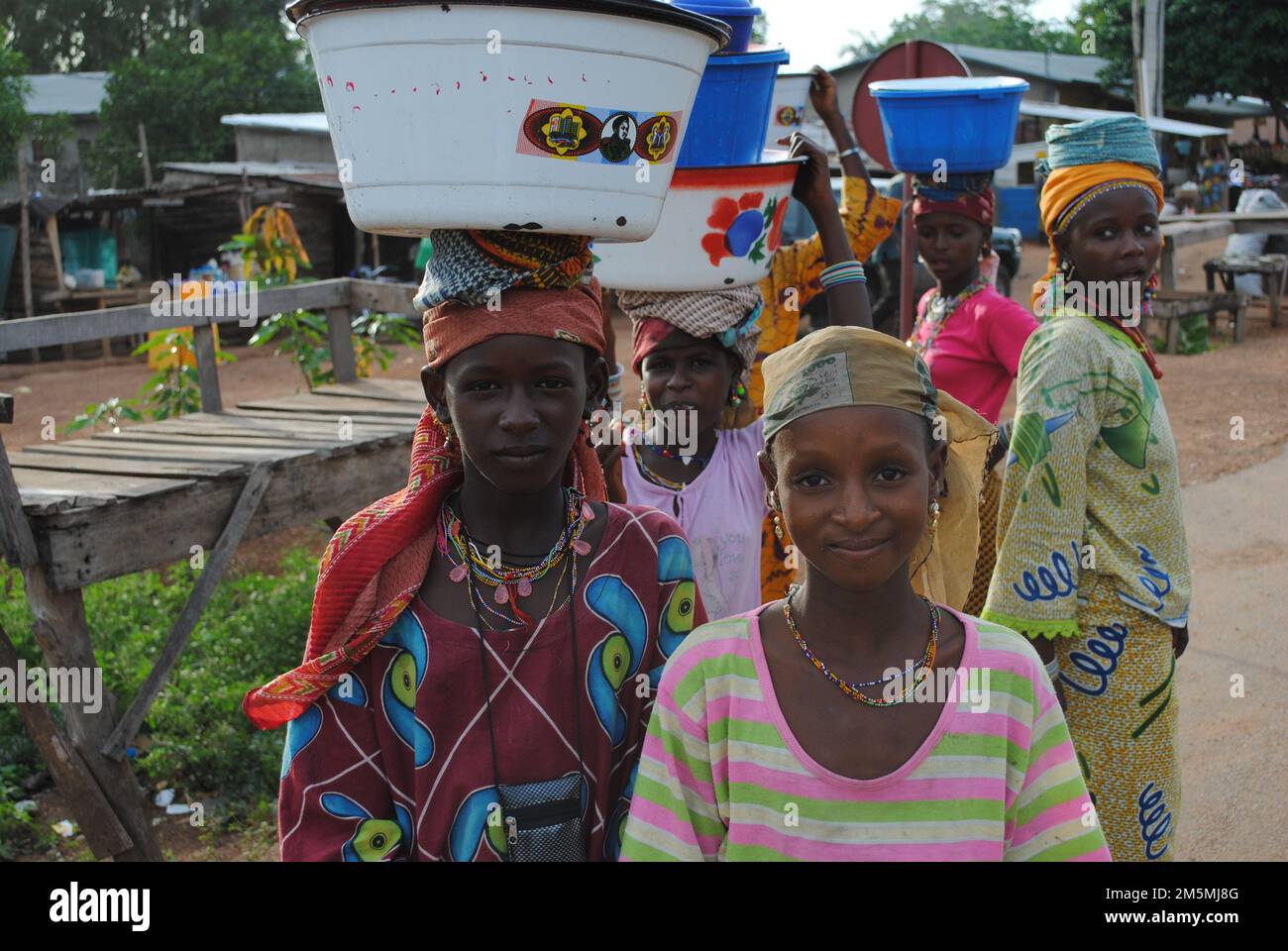 Group of african teenager girls selling food alongside the road Benin ...