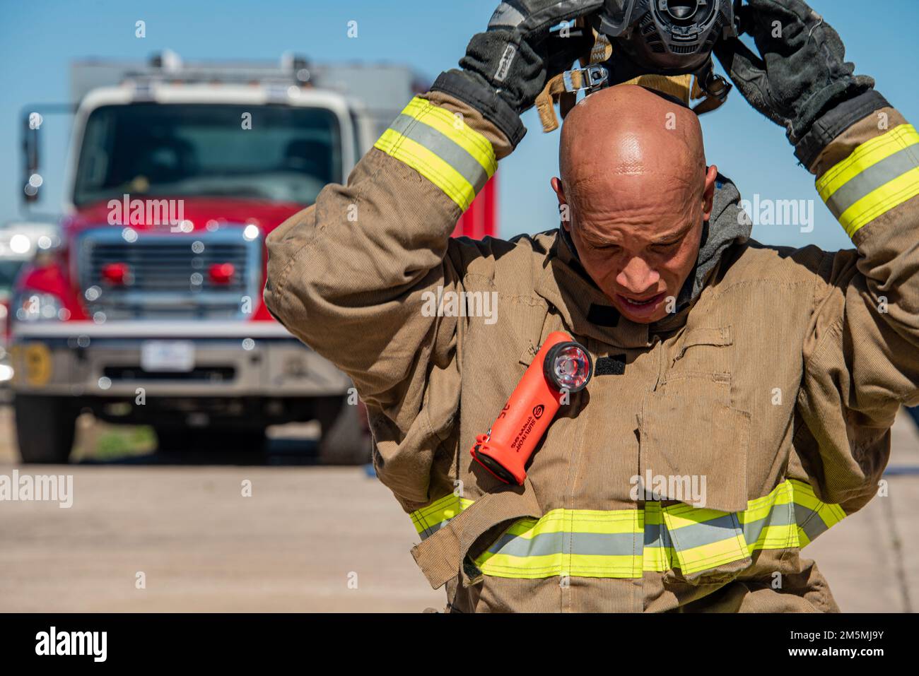 A local firefighter from the 260th Army Engineer Fire Detachment, takes ...