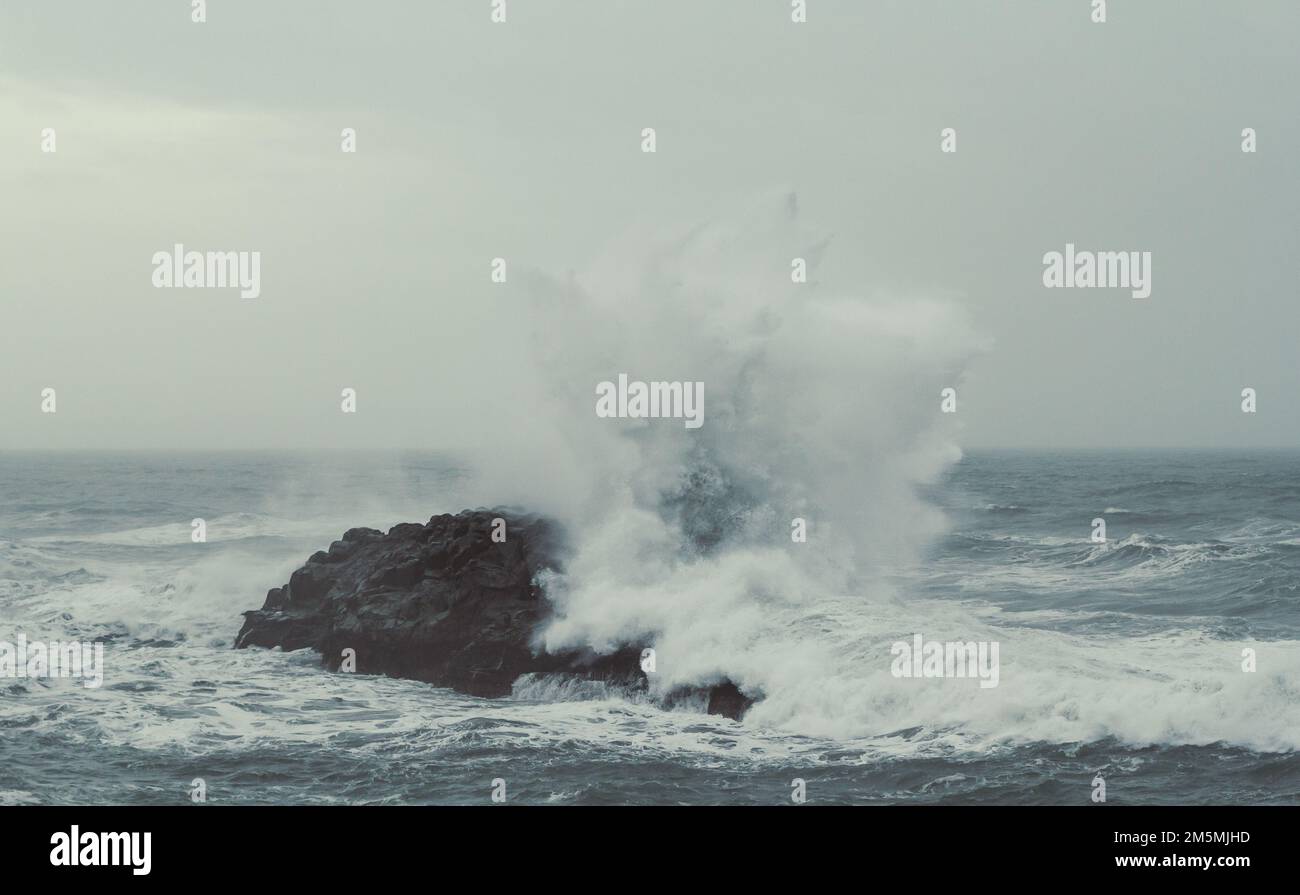 Large rock and water splash on storm landscape photo Stock Photo - Alamy