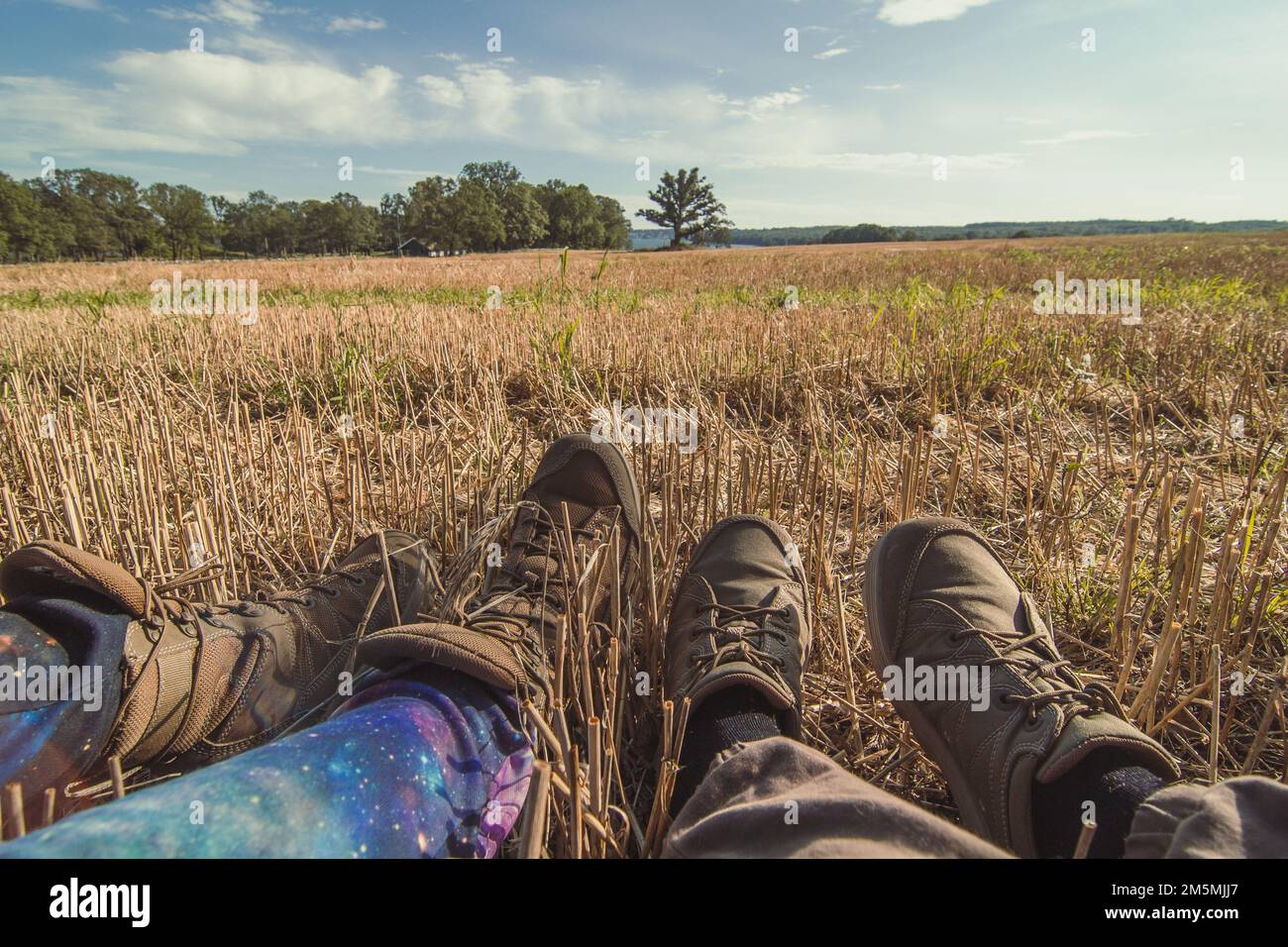Close up tired tourist resting in mowed field concept photo Stock Photo ...