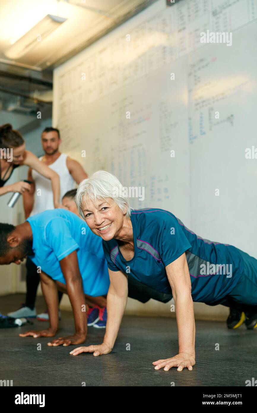 Youve gotta stay healthy. a group of people working out in the gym ...