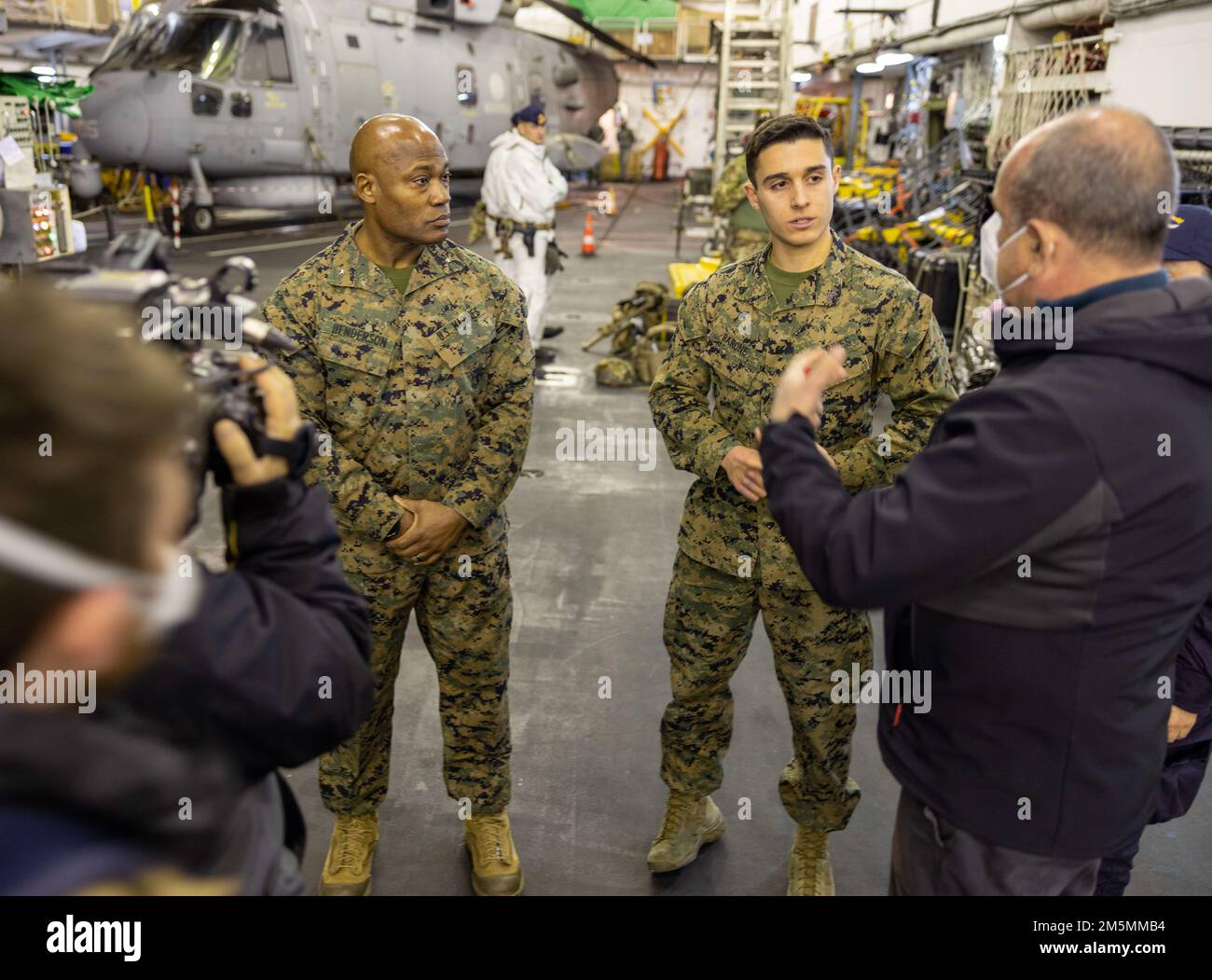 U.S. Marine Corps Cpl. Stefano Barone, right, translates questions from ...