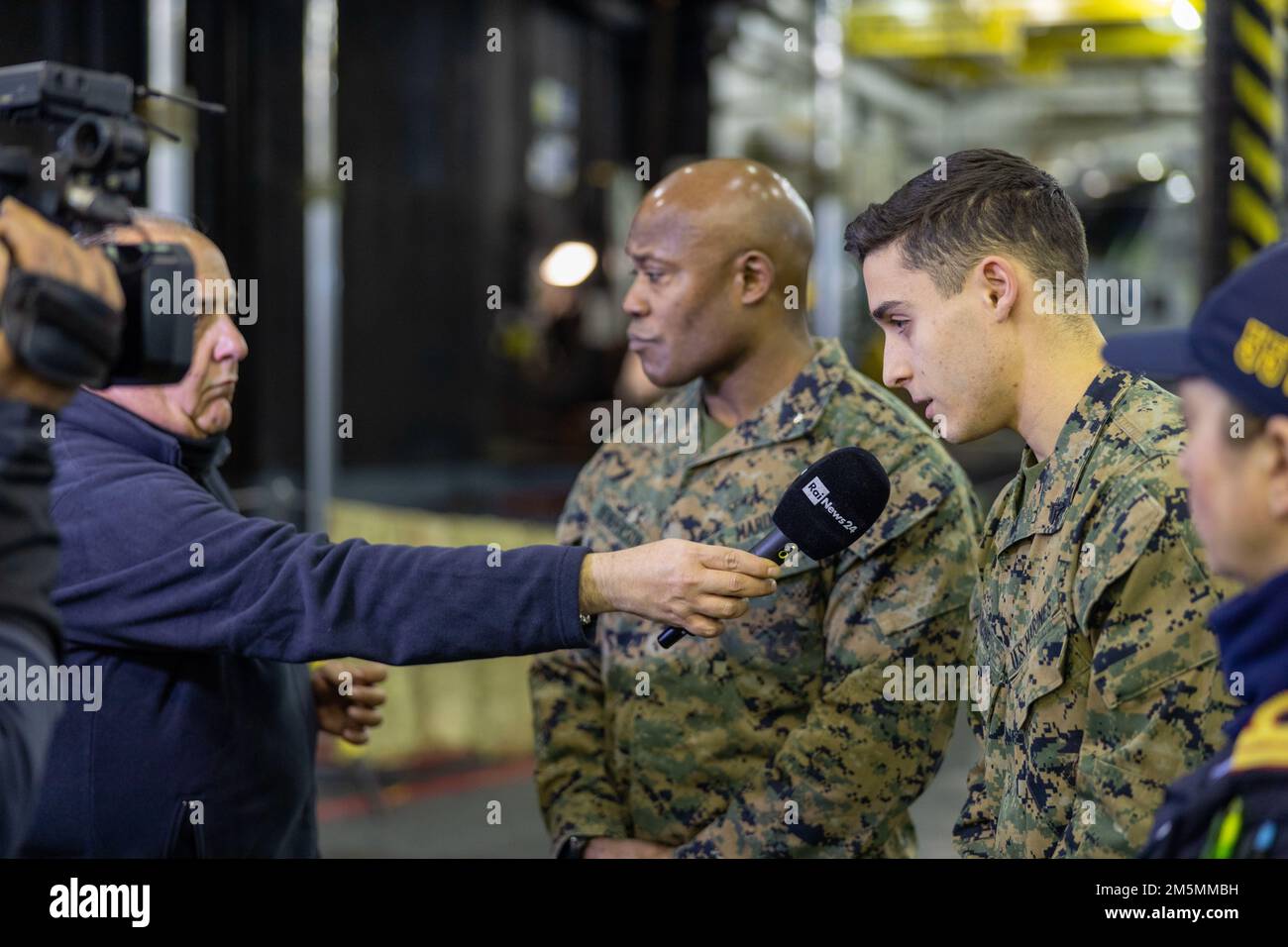 U.S. Marine Corps Cpl. Stefano Barone, right, translates questions from ...
