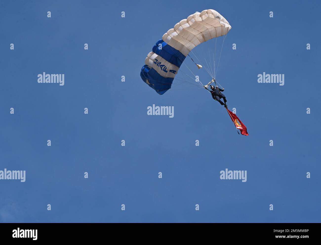A member of the Wings of Blue Parachute Team, displays the United ...
