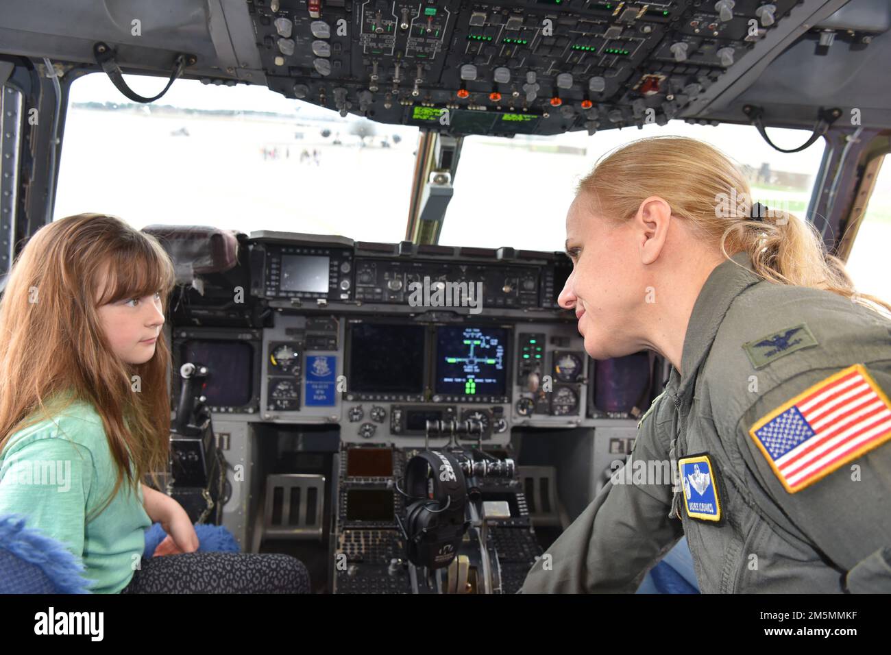 U.S. Air Force 305th Operations Group commander, answers questions from a young girl inside the ...