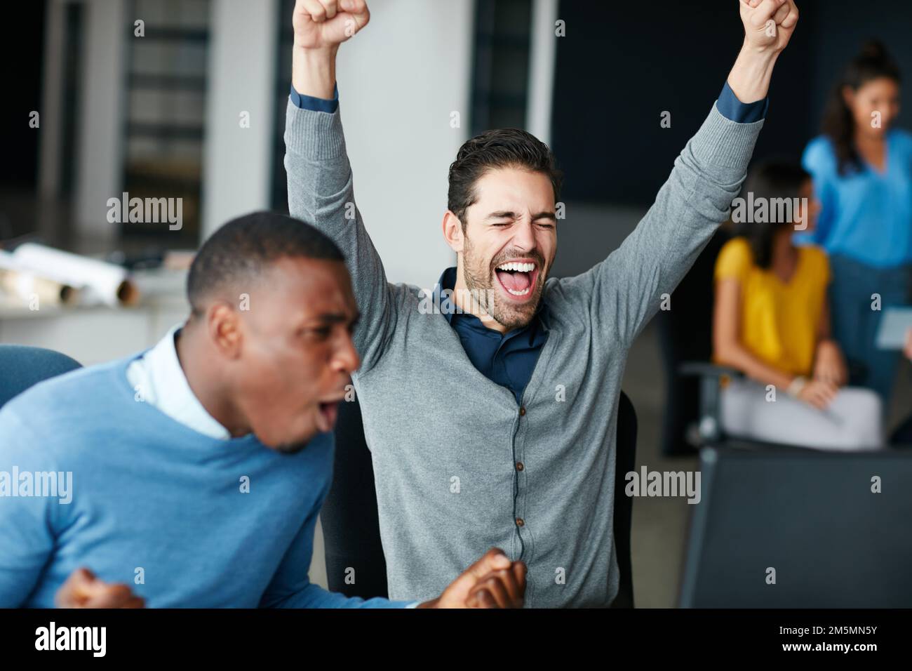 Hell yeah. two businessmen cheering in the office Stock Photo - Alamy