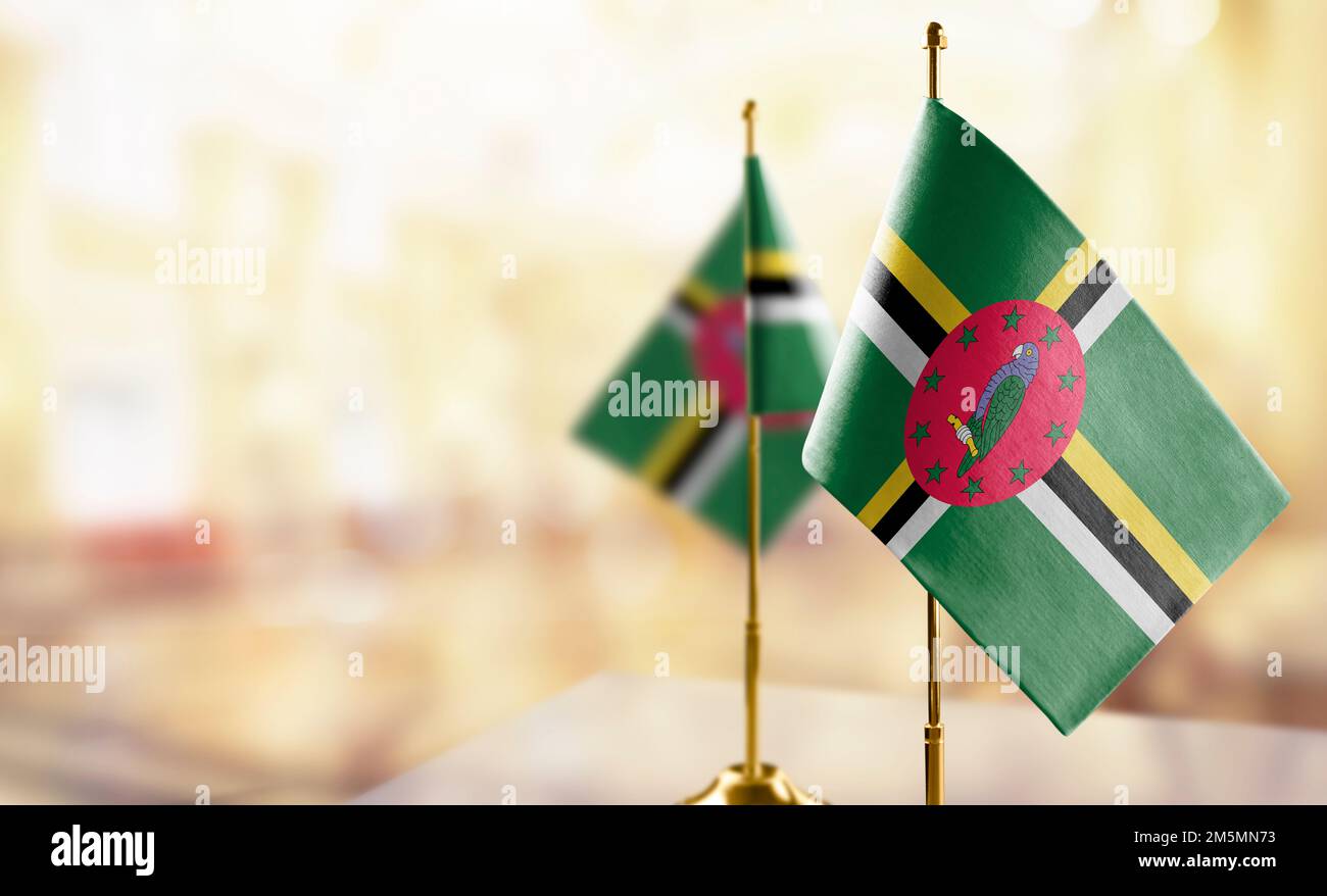 Small flags of the Dominica on an abstract blurry background Stock ...