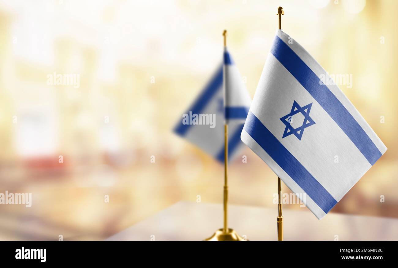 Small flags of the Israel on an abstract blurry background Stock Photo ...