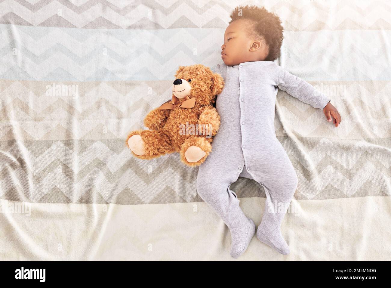 Sleep is a bear necessity of life. High angle shot of a little baby boy ...