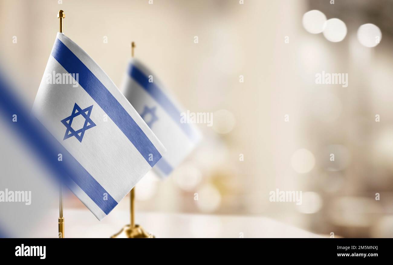 Small flags of the Israel on an abstract blurry background Stock Photo ...