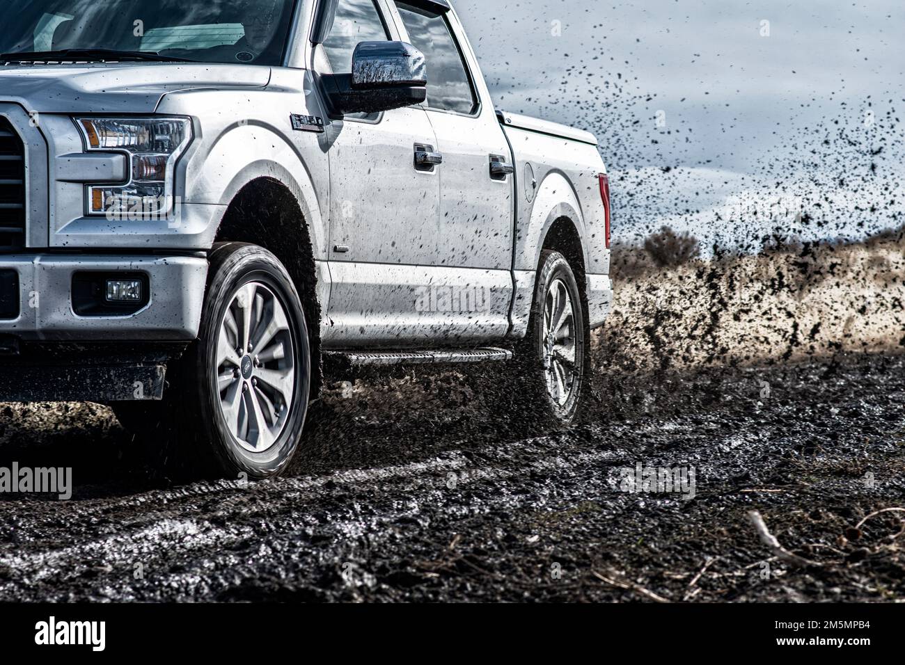 The Ford F150 Silver Truck Car 4x4 SUV driving in the mud Stock Photo ...