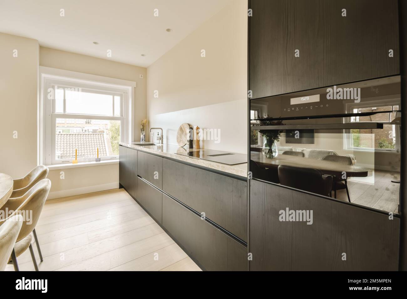 a modern kitchen with black cabinets and white counter tops in an open ...