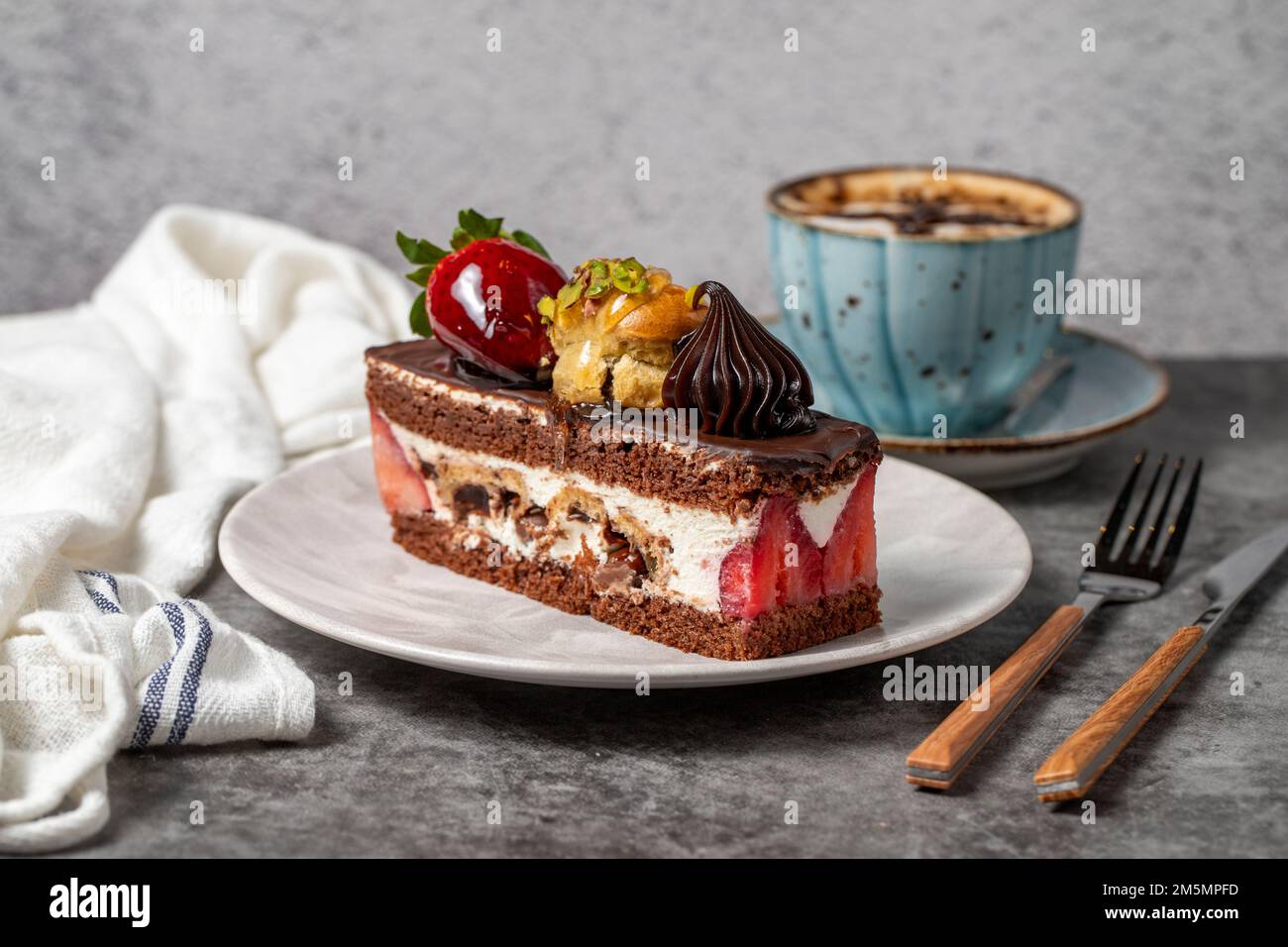 Strawberry and chocolate cake on a dark background. Slice of layered ...