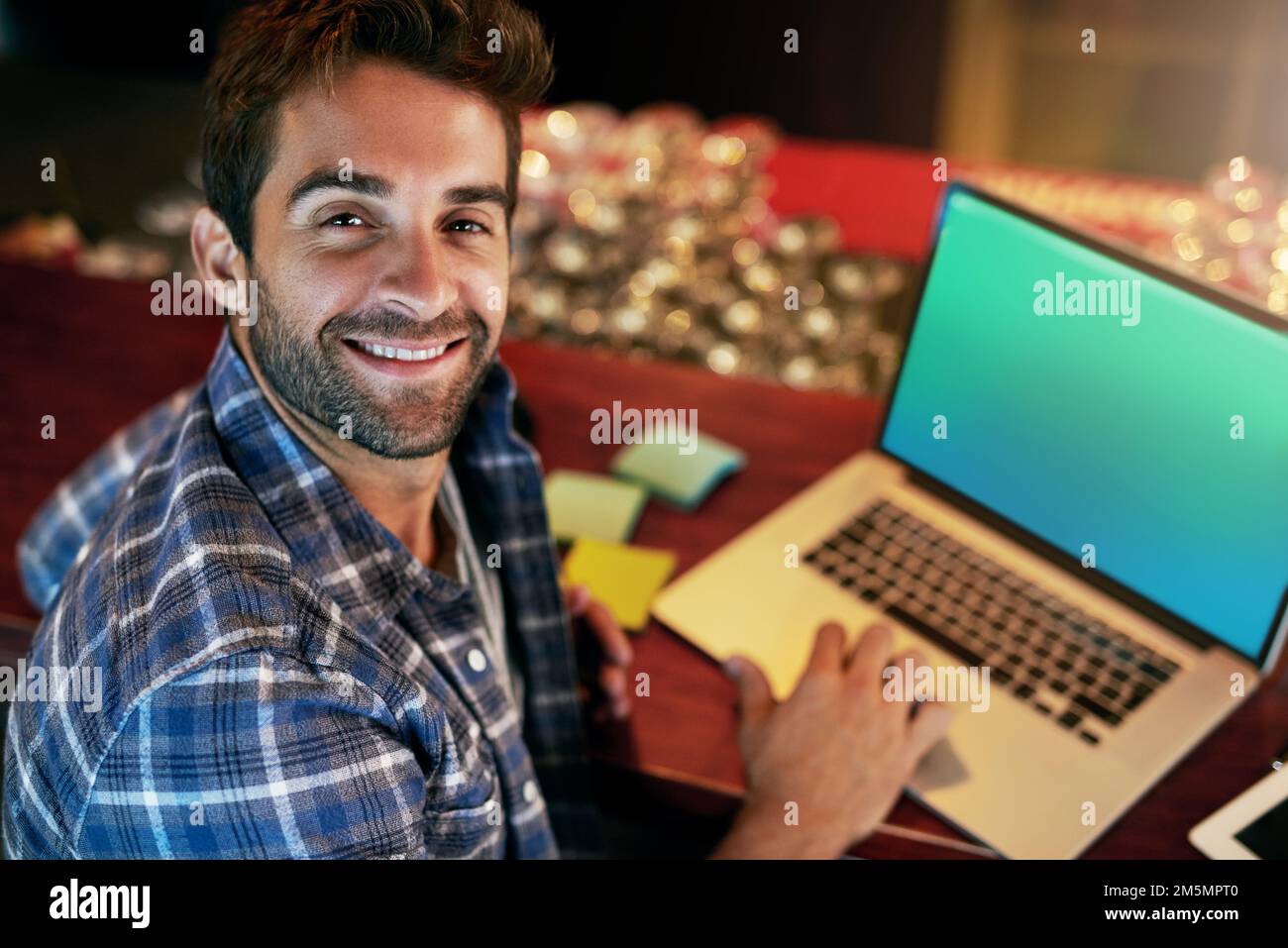 Making use of the free wifi. High angle shot of a handsome young man ...