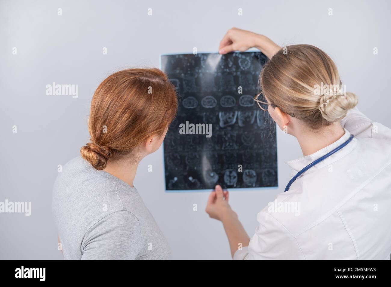 Female doctor explaining mri of internal organs to female patient Stock ...