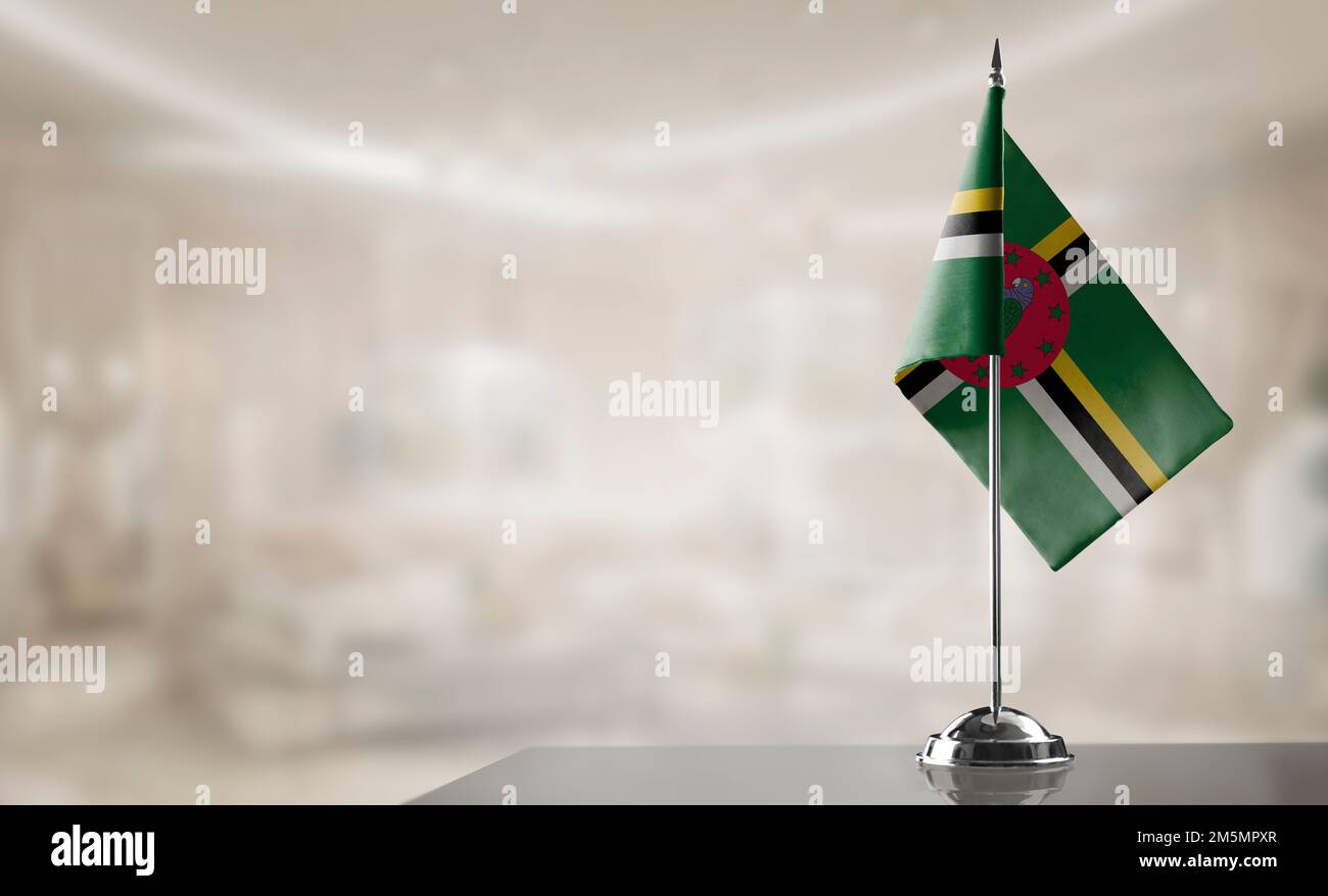 A small Dominica flag on an abstract blurry background Stock Photo - Alamy