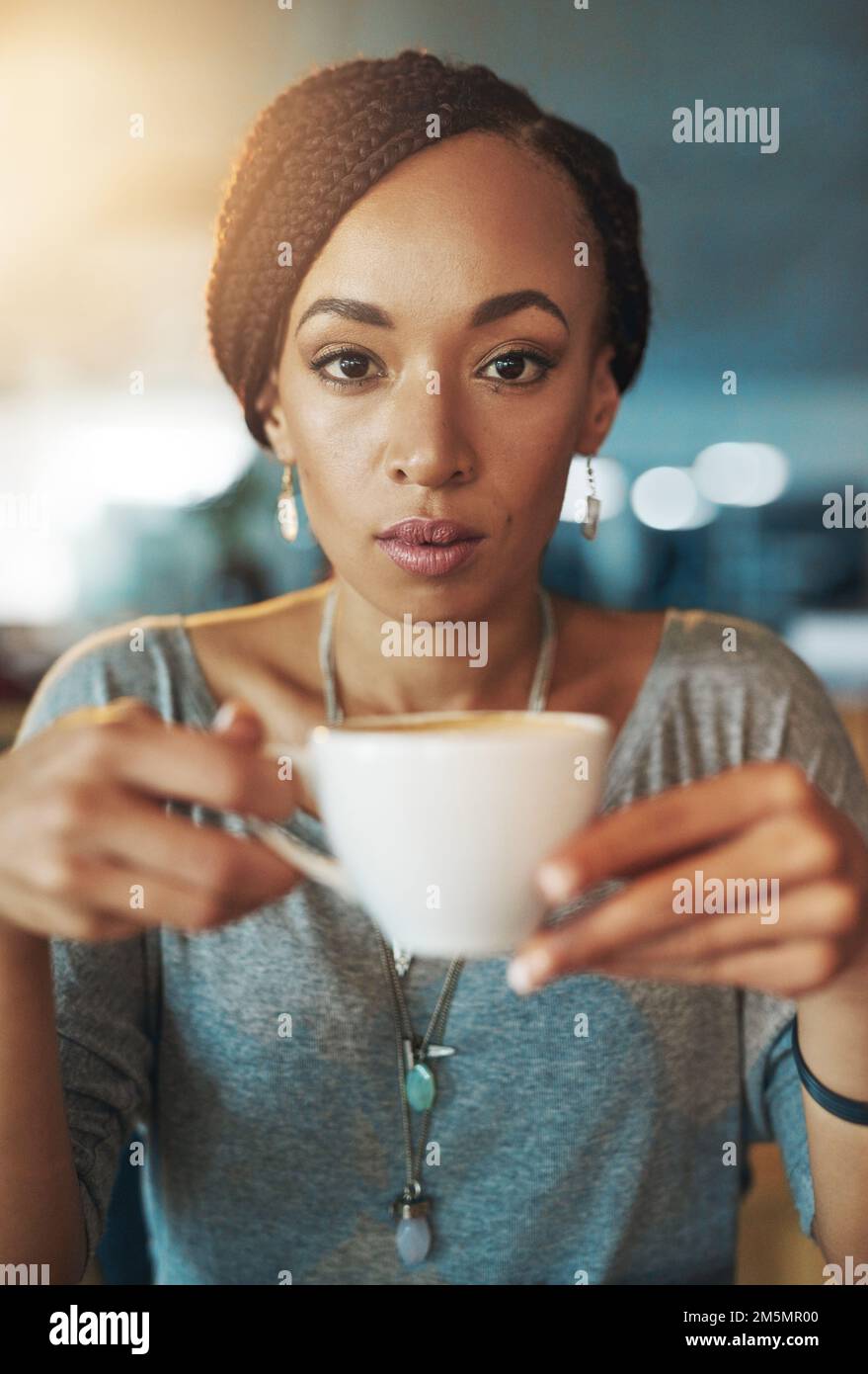 Just a little coffee to get me going. Cropped portrait of a young woman ...