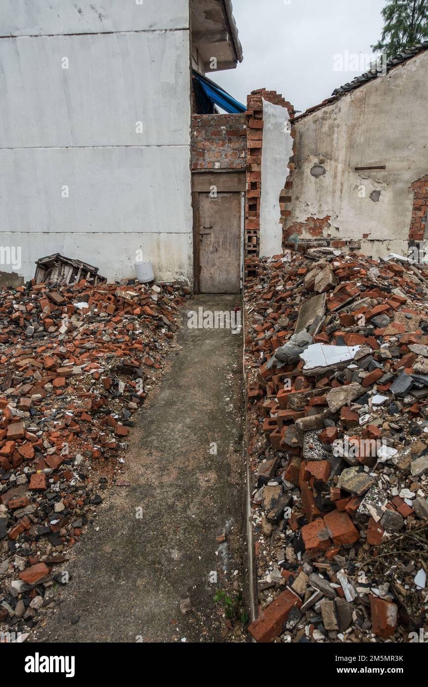 A vertical closeup shot of ruined buildings and pieces of stones after ...