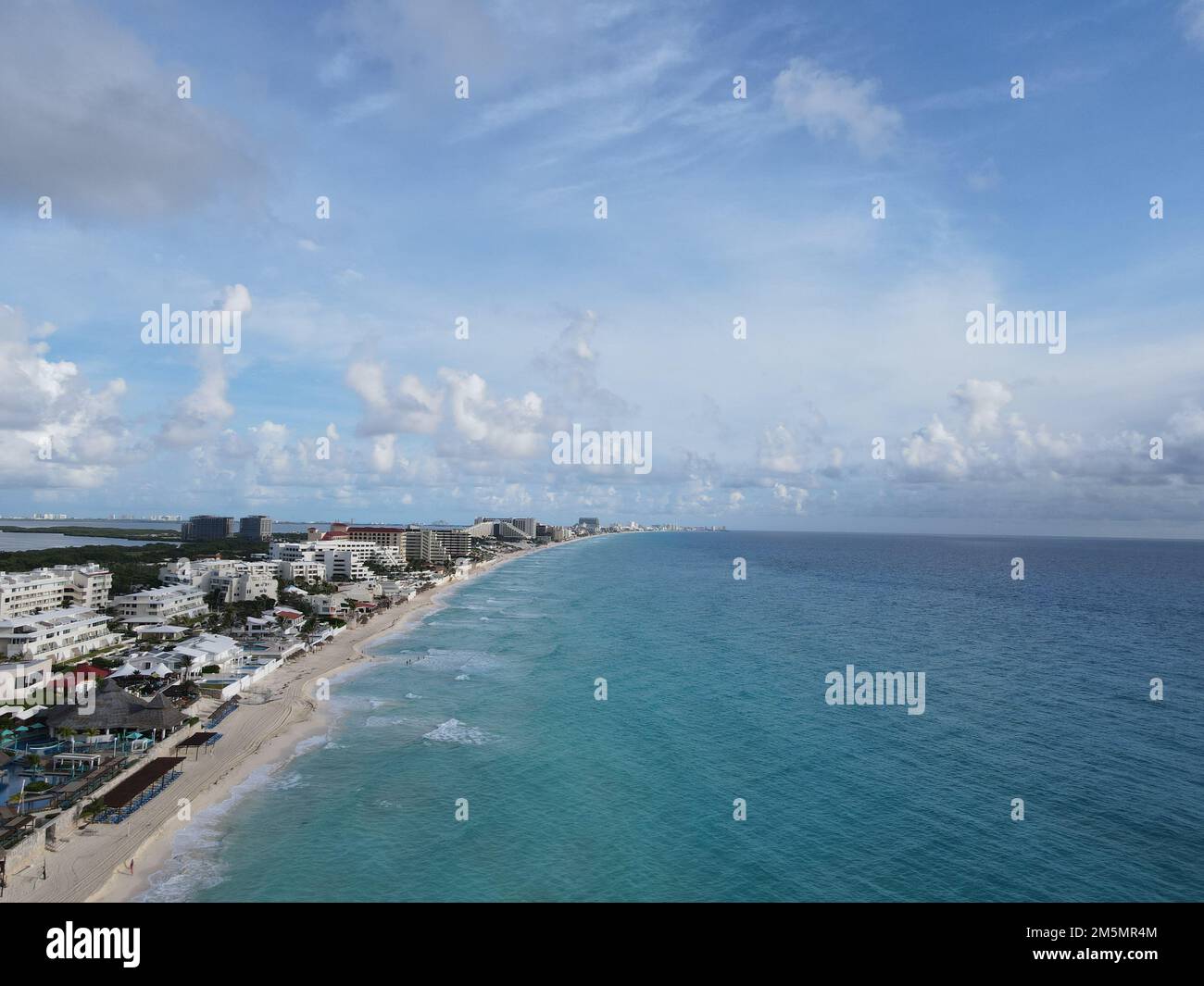 An aerial shot of the coastal city of Cancun with hotels and resorts in ...