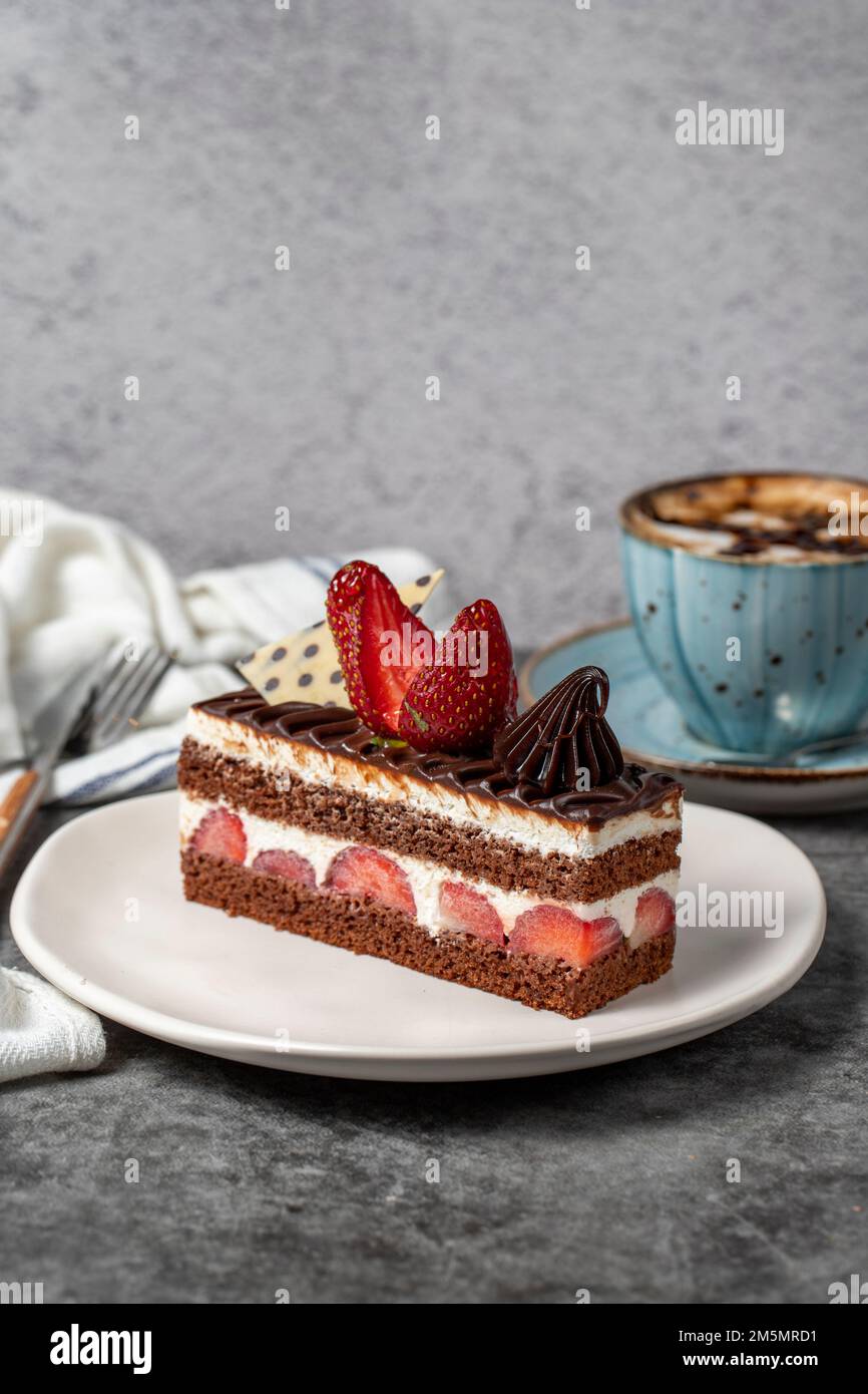 Strawberry and chocolate cake on a dark background. Slice of layered ...
