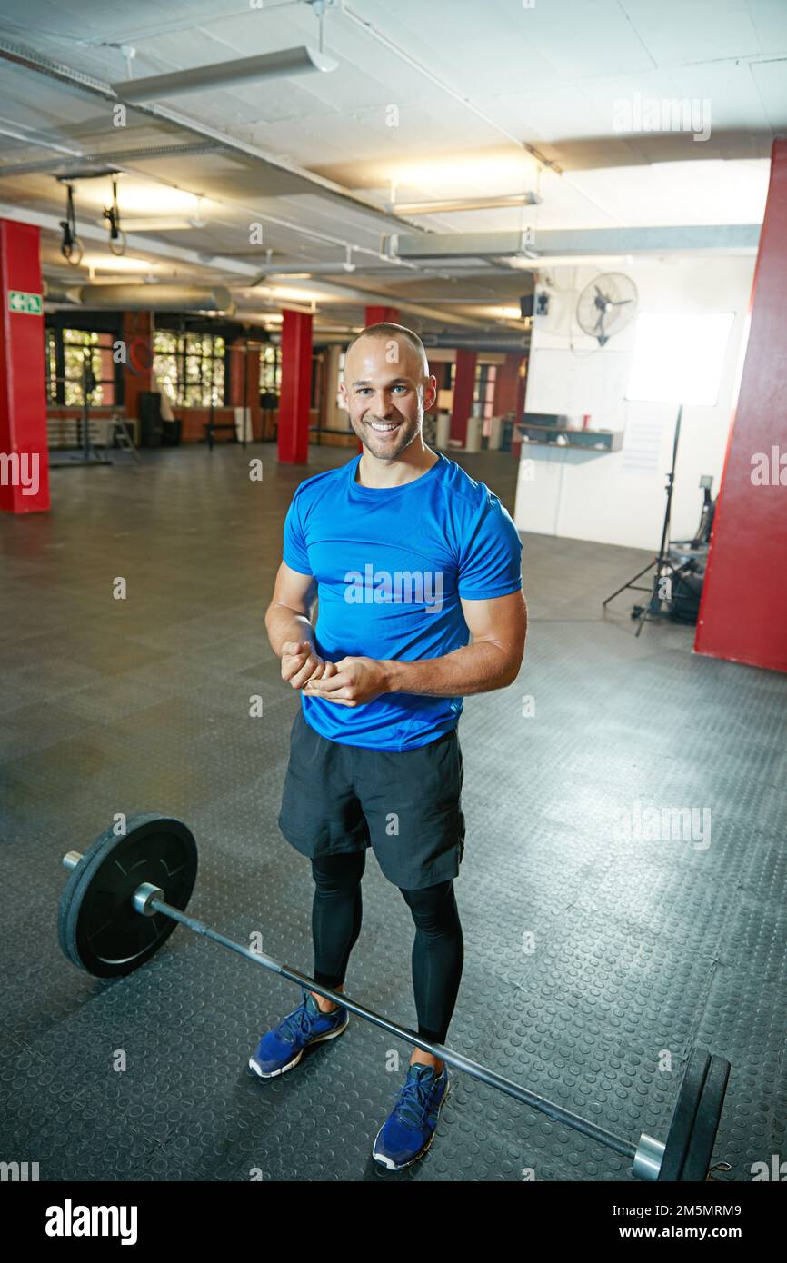 Its a good day to lift something heavy. Portrait of a young man at the ...
