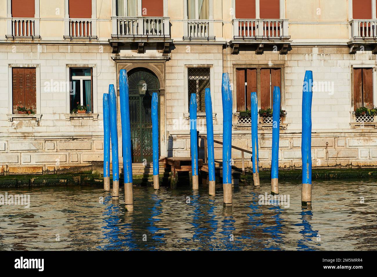 empty pier with typical blue venetian posts in front of the entrance of ...