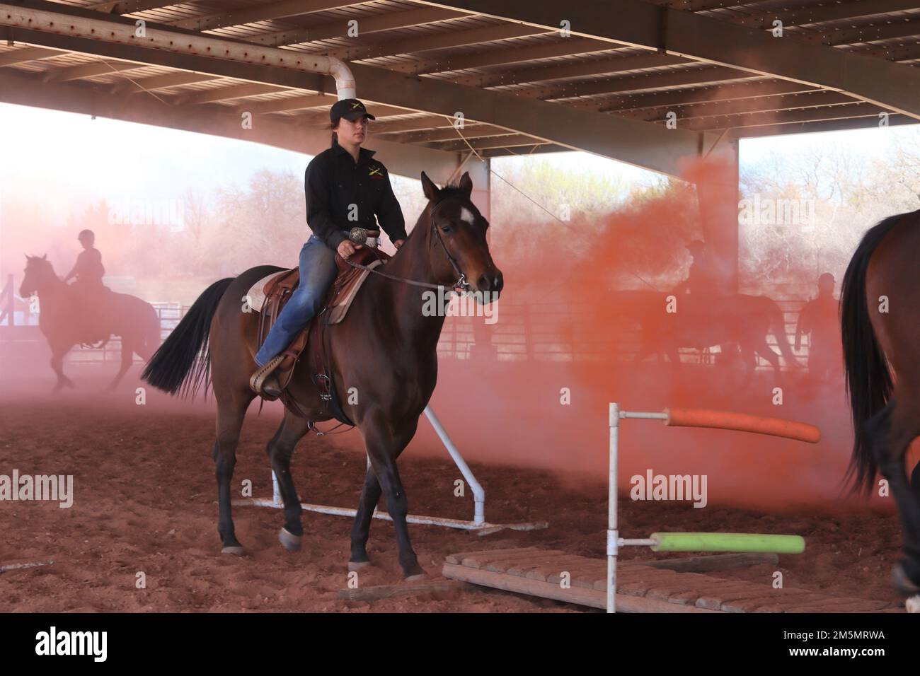Pvt. 1st Class Alexis Raymond rides Ott through an obstacle course ...