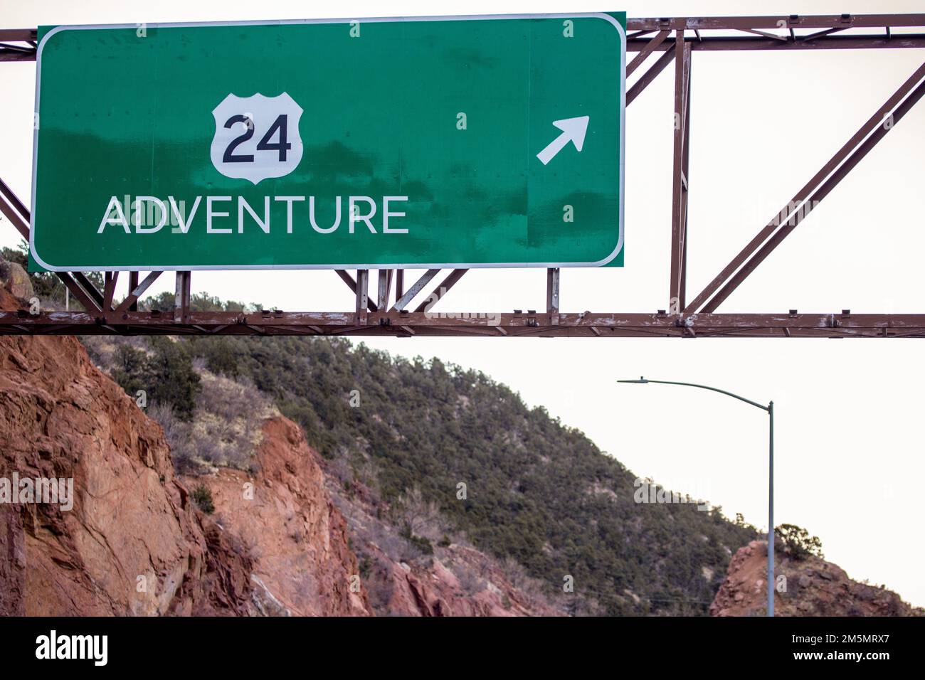 A closeup view of an adventure highway sign on mountain highway Stock ...