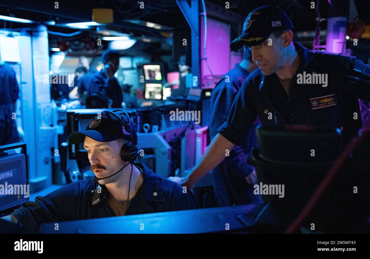 PHILIPPINE SEA (March. 27, 2022) Lt. Cdr. Alex Rose, left, and Cdr ...