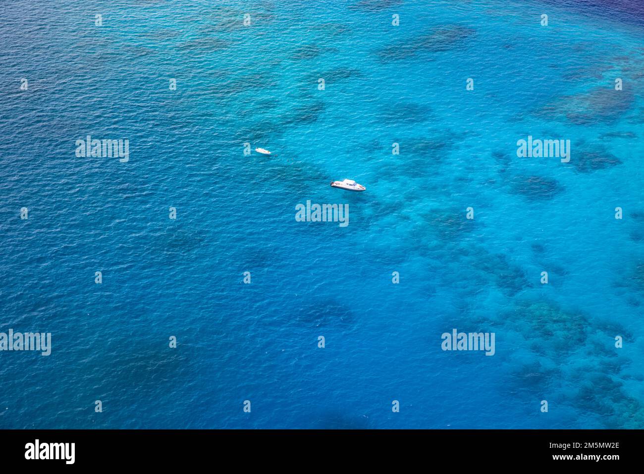 Aerial view sailing boat next to reef. Bird eye view, water sport theme ...