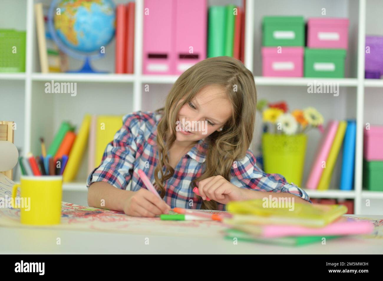 girl drawing picture at desk at home Stock Photo - Alamy