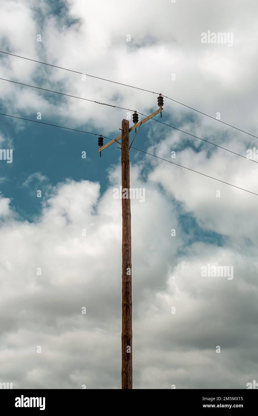 Vertical image of a utility pole against a cloudy sky Stock Photo - Alamy
