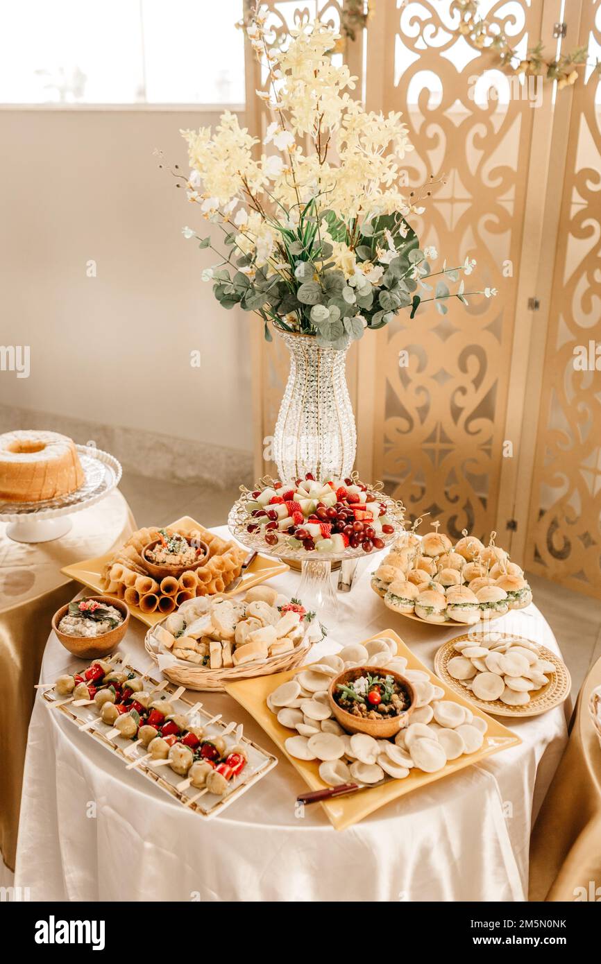 A high angle shot of banquet tables full of beautifully decorated food ...