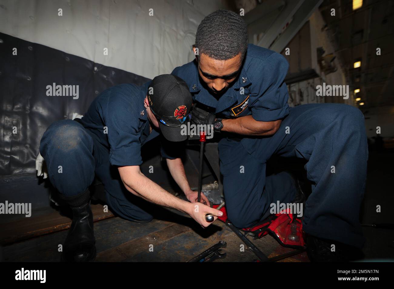 Machinist's Mate 3rd Class Timothy Almeida, from New York, (right) and ...