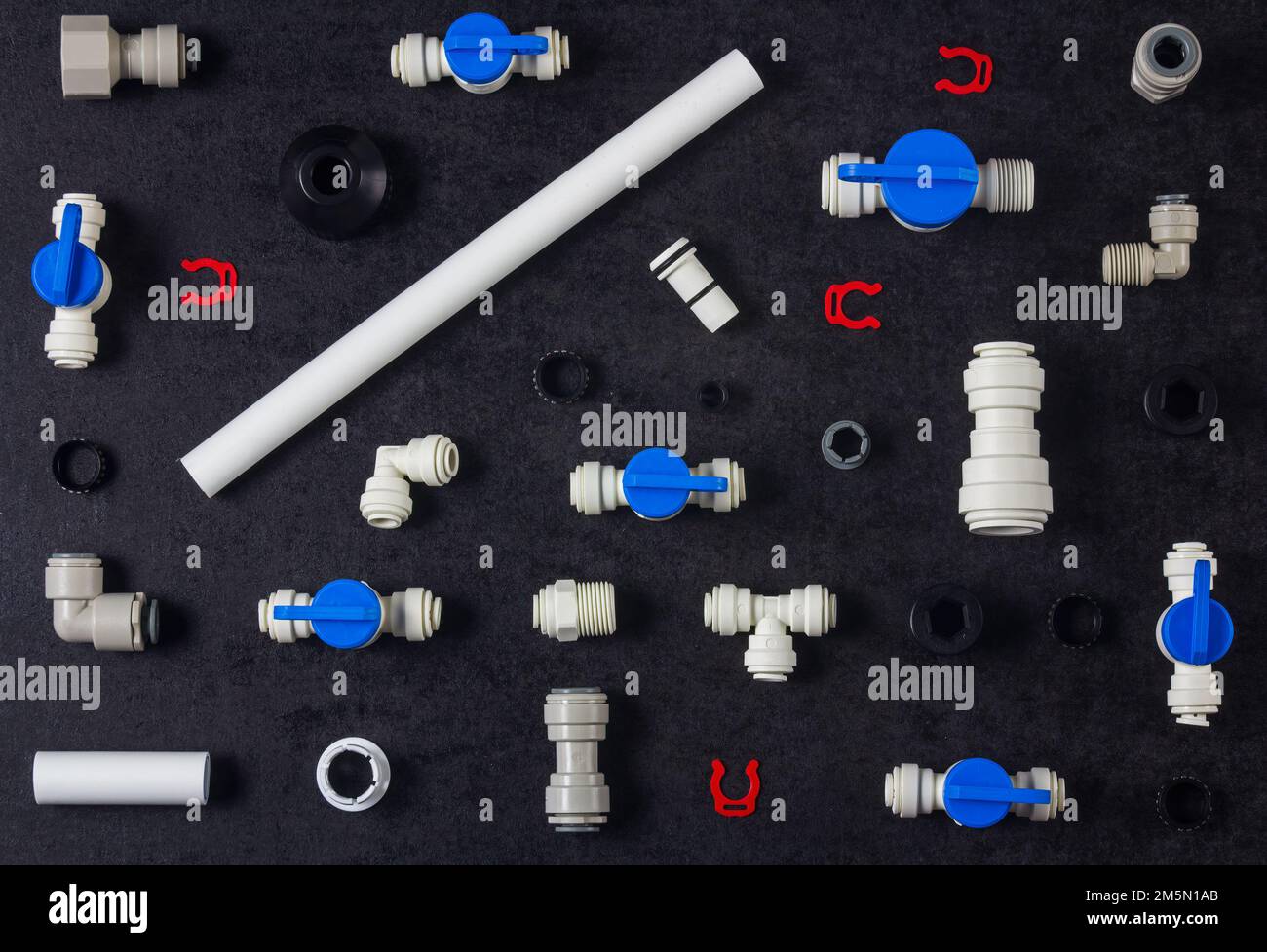 Top view photo of plastic plumbing, air product, pipe and tools. Valves ...