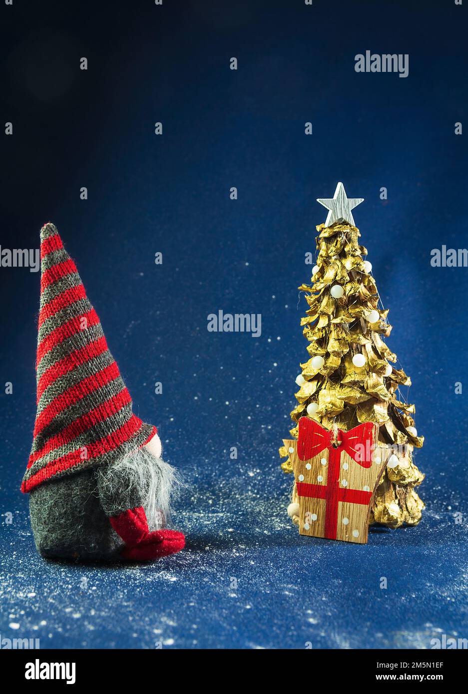 Christmas decoration elf, dwarf walking to christmas tree with gift ...