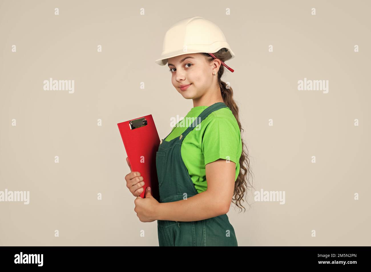 Safety expert. kid wear helmet on construction site. teen girl builder ...