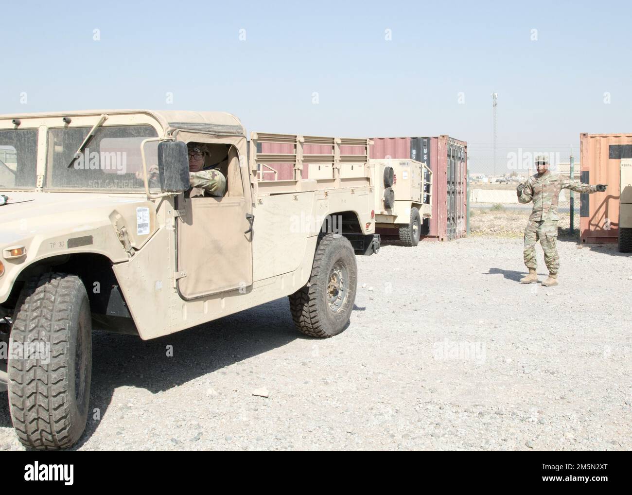 Staff Sgt. Cedric R. Matthews ground guides Sgt. Landon M. Schlotfeldt ...