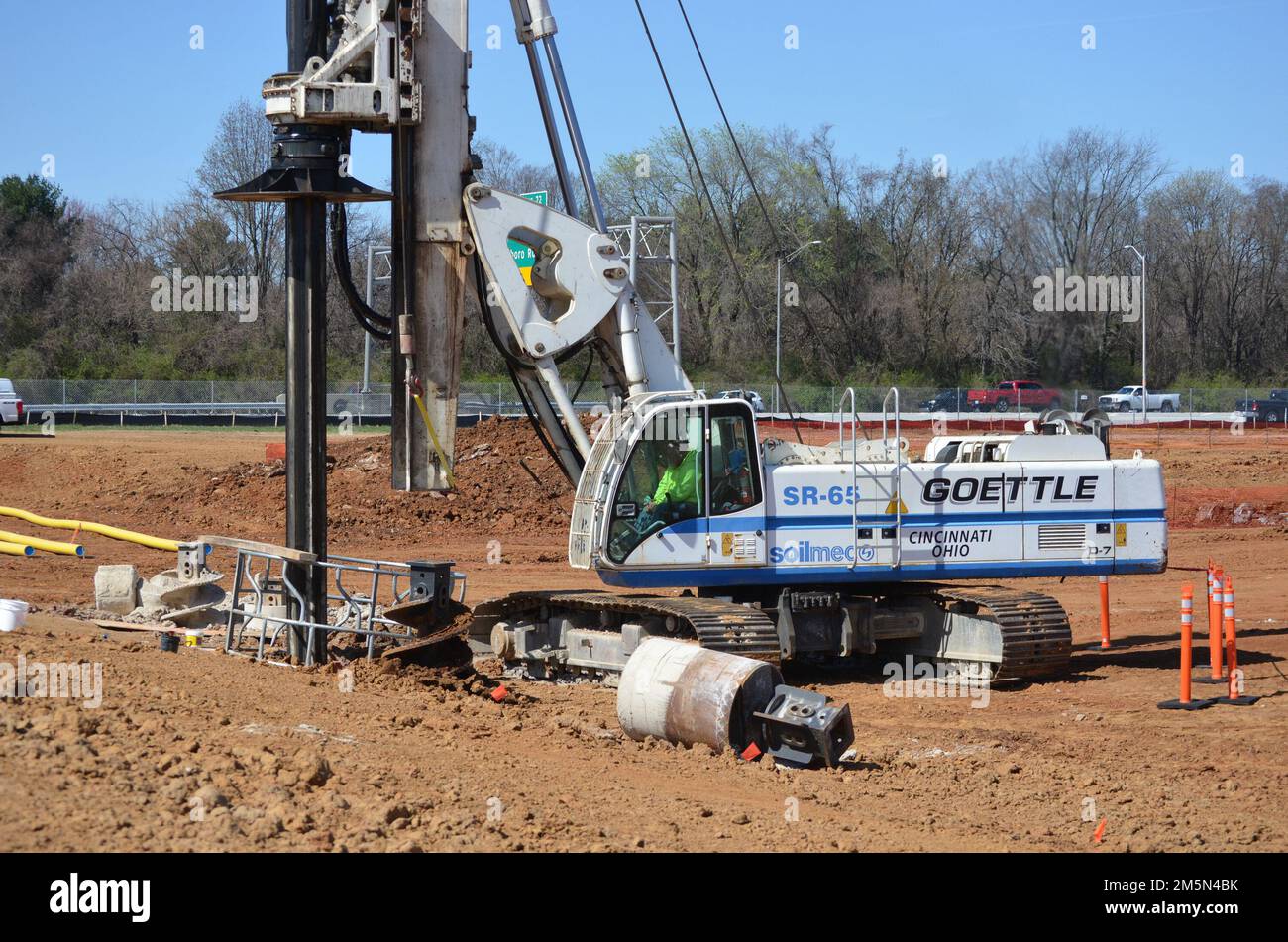 A contractor uses a drill rig to remove soil overburden March 28. The ...