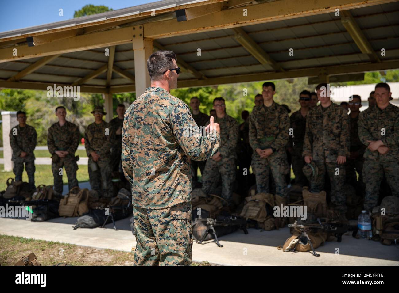 U.S. Marine Corps Staff Sgt. Adam W. Hess, center, an operations chief ...