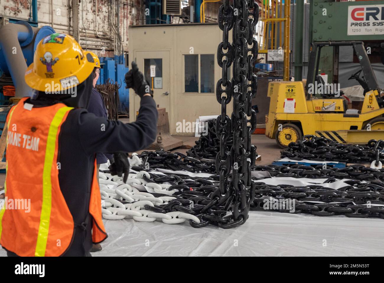 Shop 72 Riggers use cranes to lift anchor chains currently being worked ...