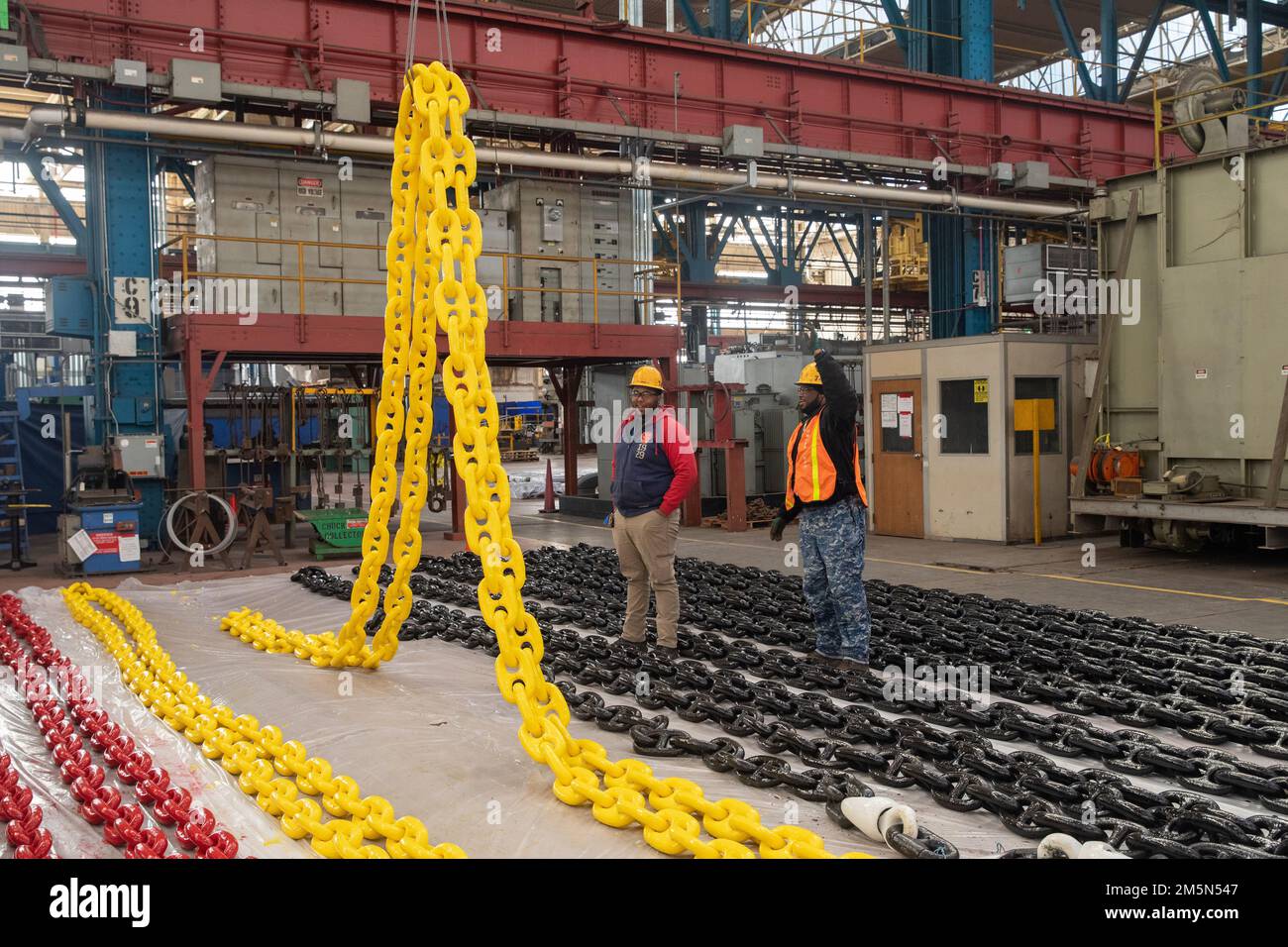 Shop 72 Riggers use cranes to lift anchor chains currently being worked ...