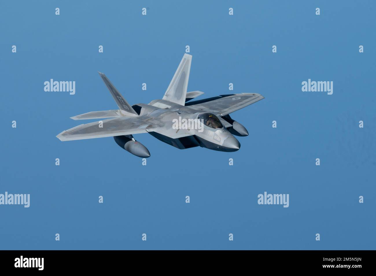 A U.S. Air Force F-22 Raptor flies above the Arabian Gulf, March 29 ...
