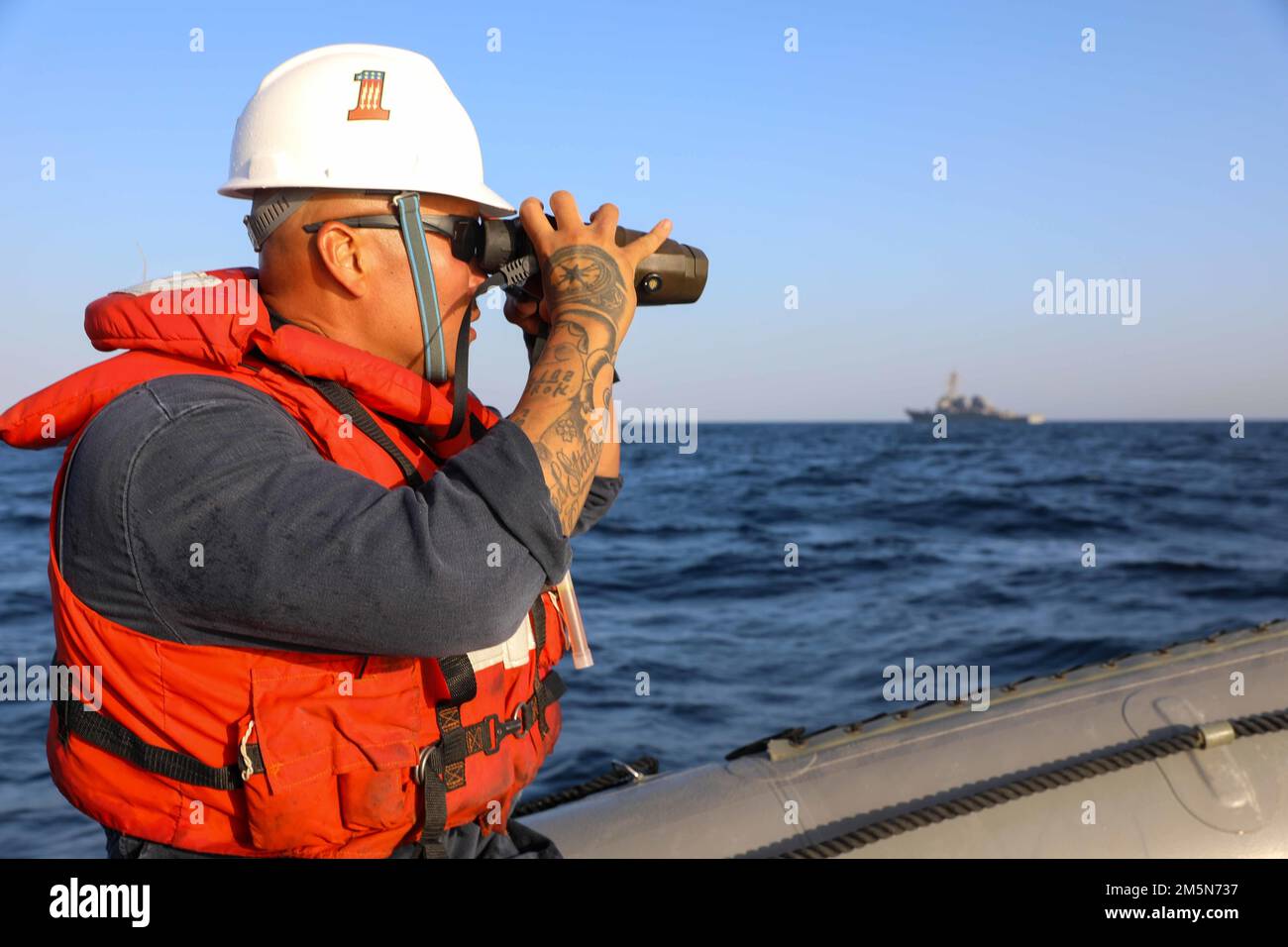 220329-N-CS075-1740 RED SEA (Mar. 29, 2022) Lt.j.g. David Yi uses a ...